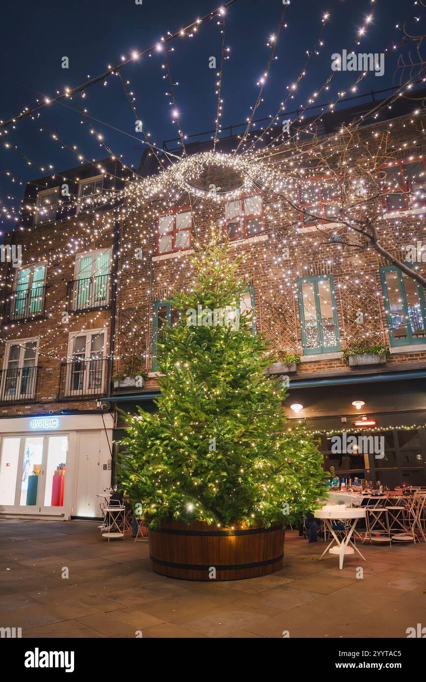 Festive Christmas Tree in a London Courtyard with Brick Architecture ...
