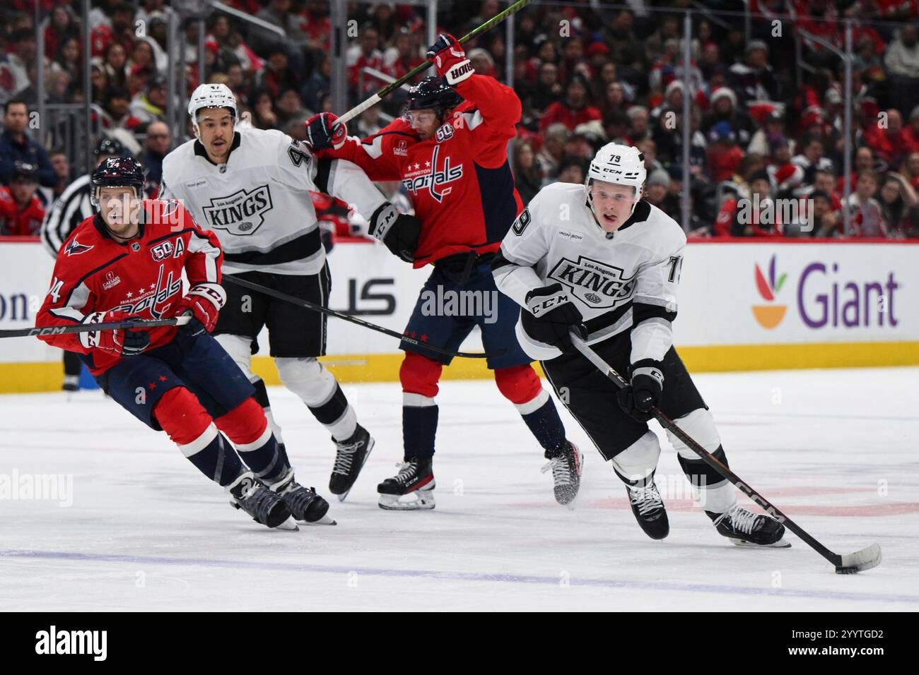 Los Angeles Kings center Samuel Helenius, right, handles the puck ...