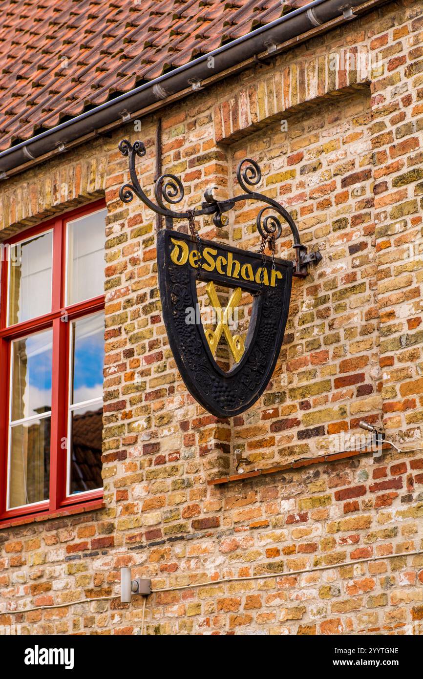 Metal decorative signs on buildings in Bruges, West Flanders, Belgium ...