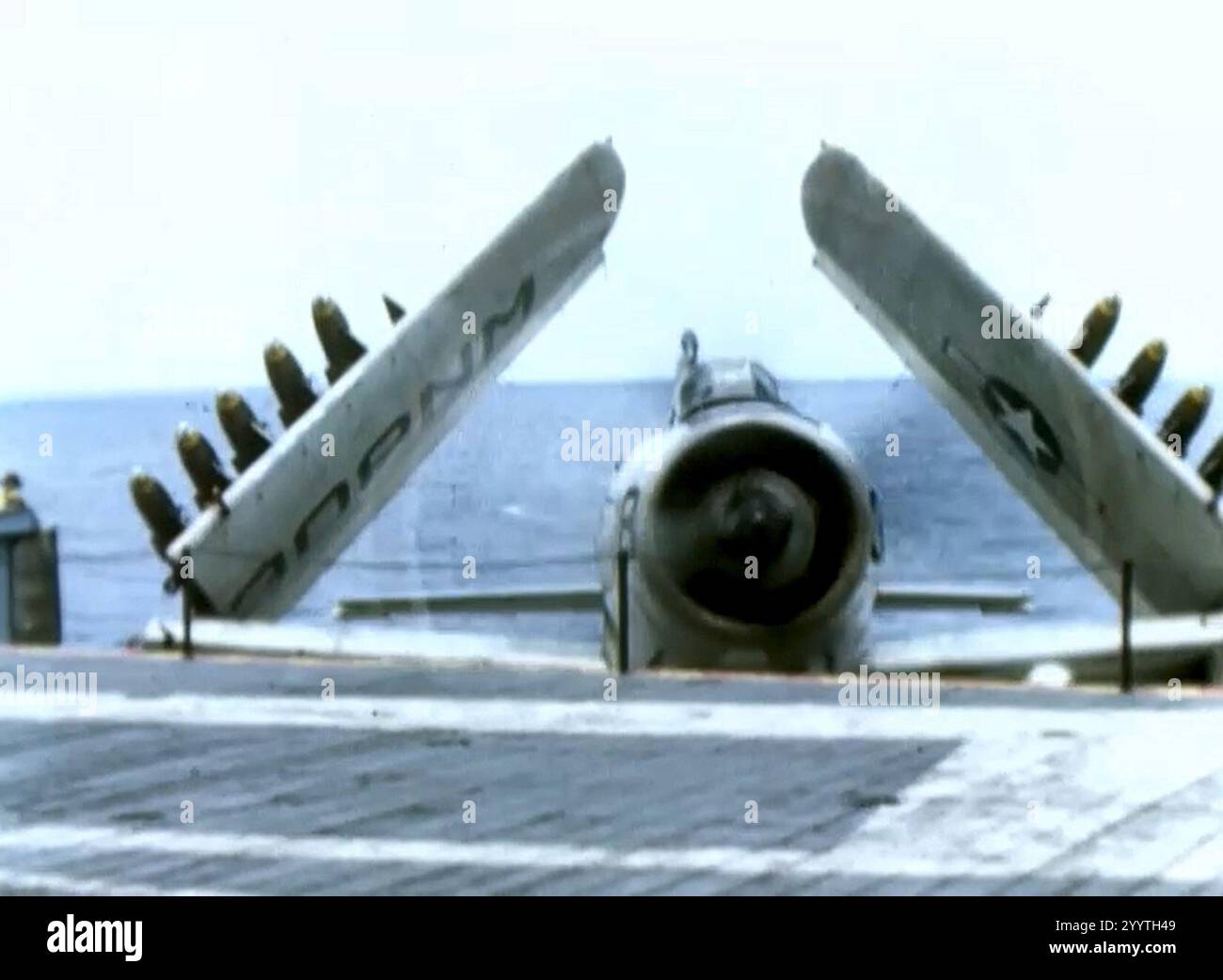 Douglas A-1H Skyraider of VA-52 is brought up to the flight deck aboard ...