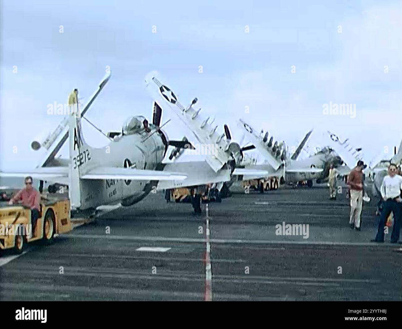 Douglas A-1H Skyraider of VA-165 is towed on the flight deck of USS ...
