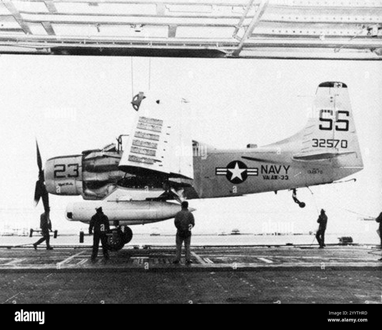 Douglas AD-5N Skyraider of VA(AW)-33 Det.34 is hoisted aboard USS Lake ...
