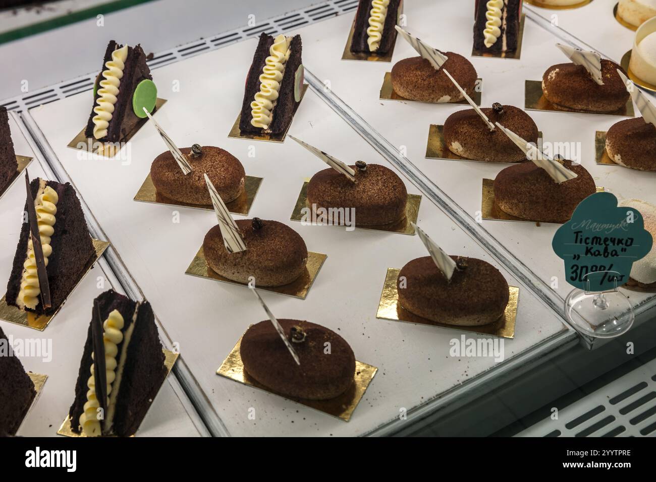 A variety of desserts are on display, including a few cakes and a ...