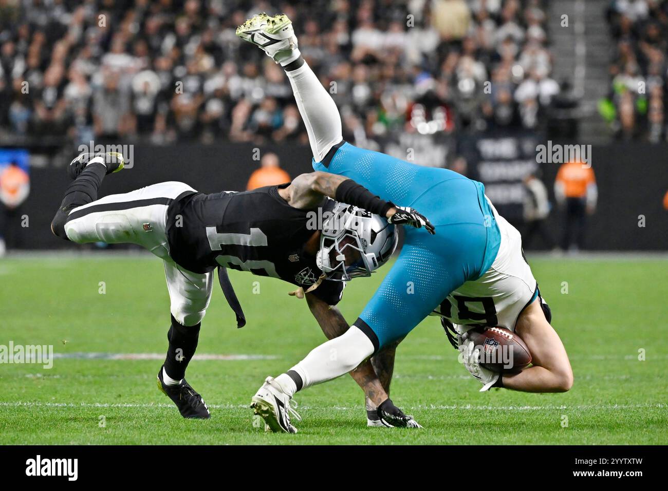 Las Vegas Raiders cornerback Jack Jones, left, takes down Jacksonville ...