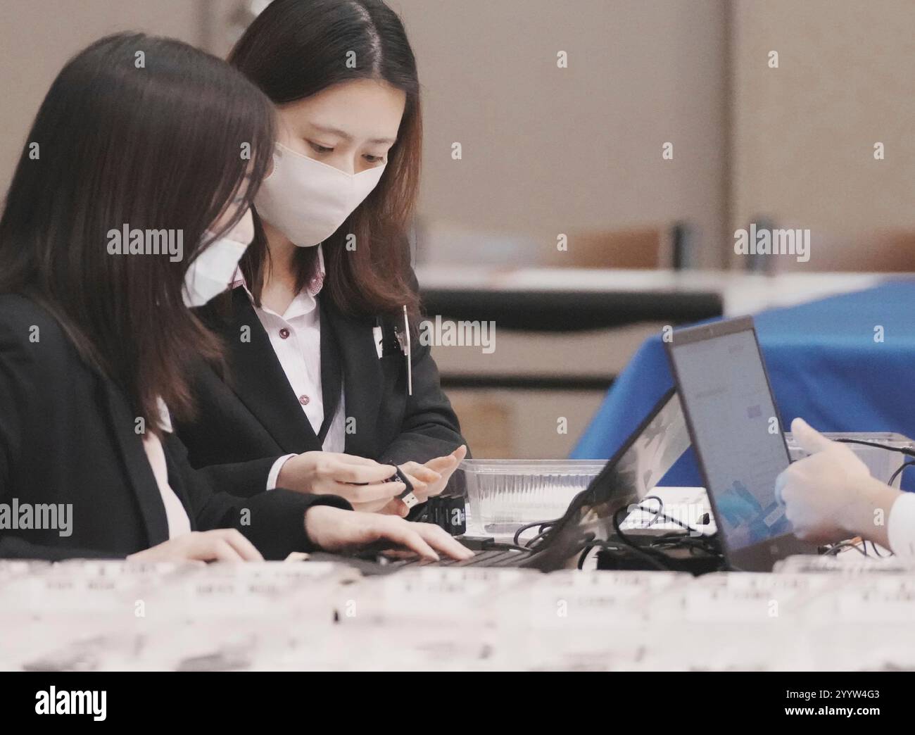 Counting work of electronic votes by loading data onto computers is ...