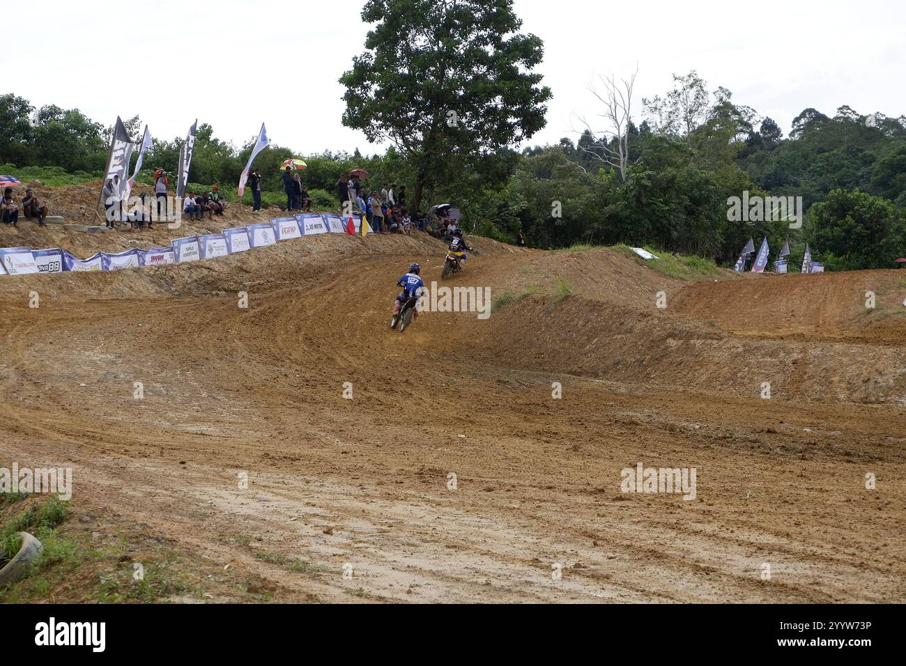 Motocross racers in action on the motocross racing circuit Stock Photo ...
