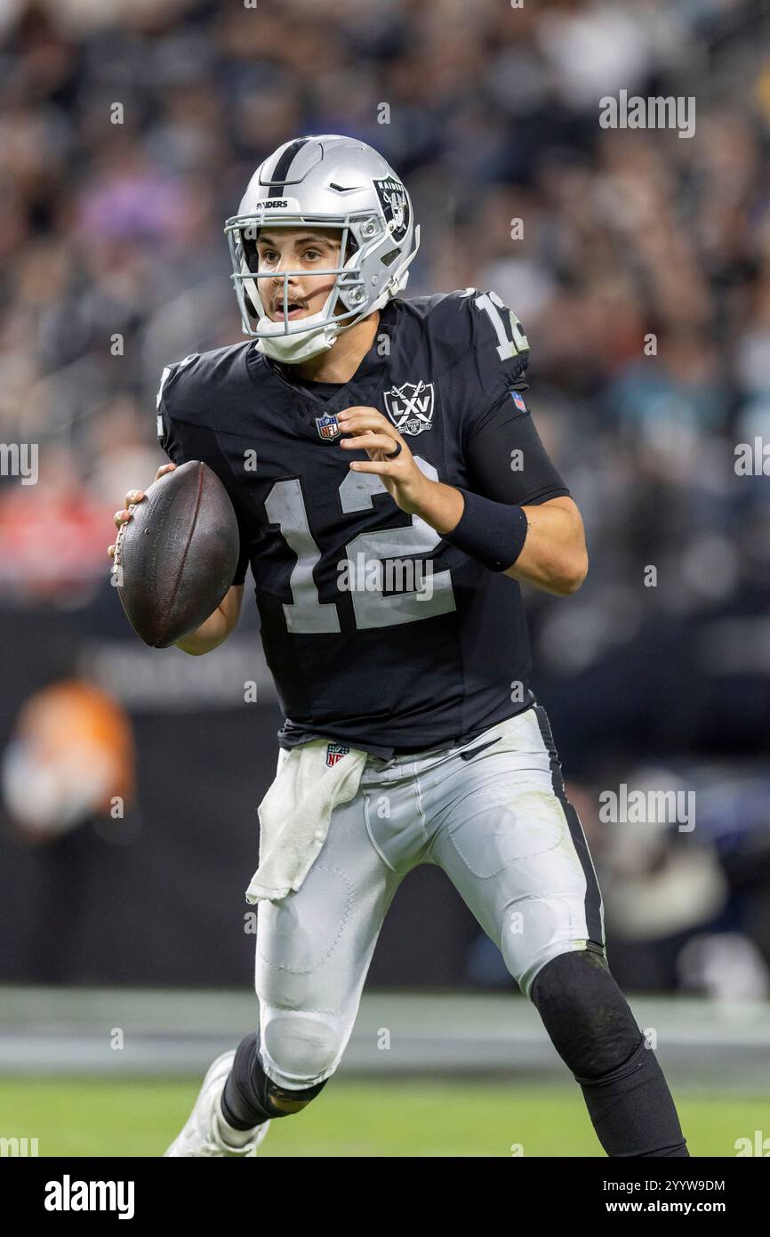 Las Vegas Raiders quarterback Aidan O'Connell (12) rolls out to pass ...
