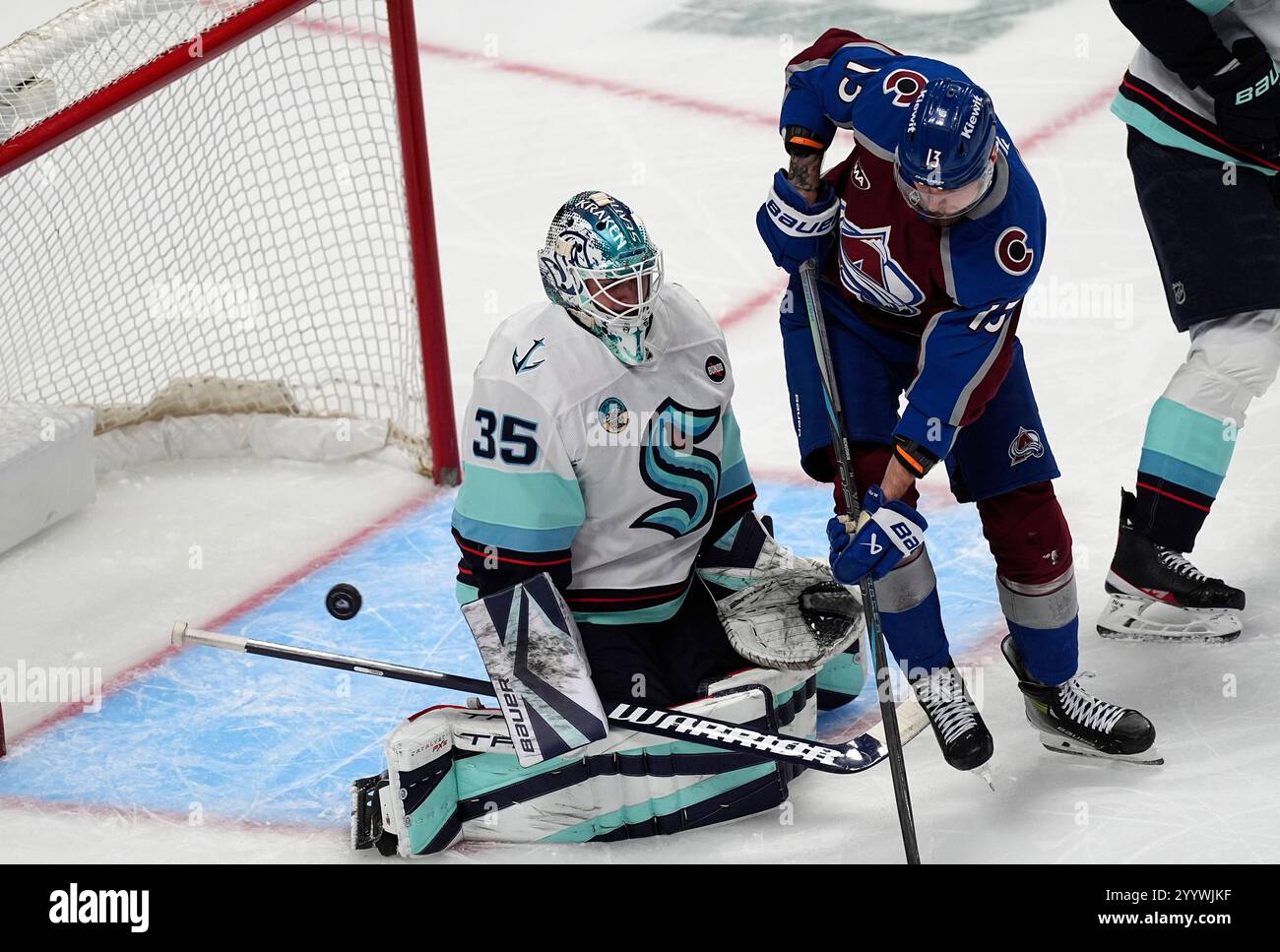Seattle Kraken goaltender Joey Daccord, left, deflects a shot by ...