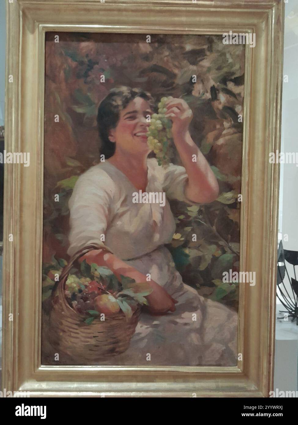 E. Caruana Dingli, Mary Anne eating grapes Stock Photo - Alamy