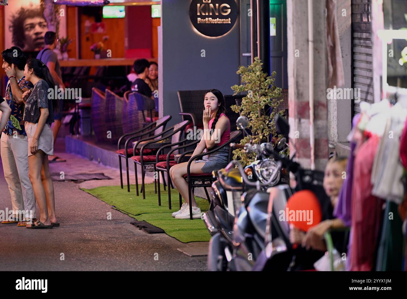 A young Thai hostess looks for customers in a bar in the nightlife area ...