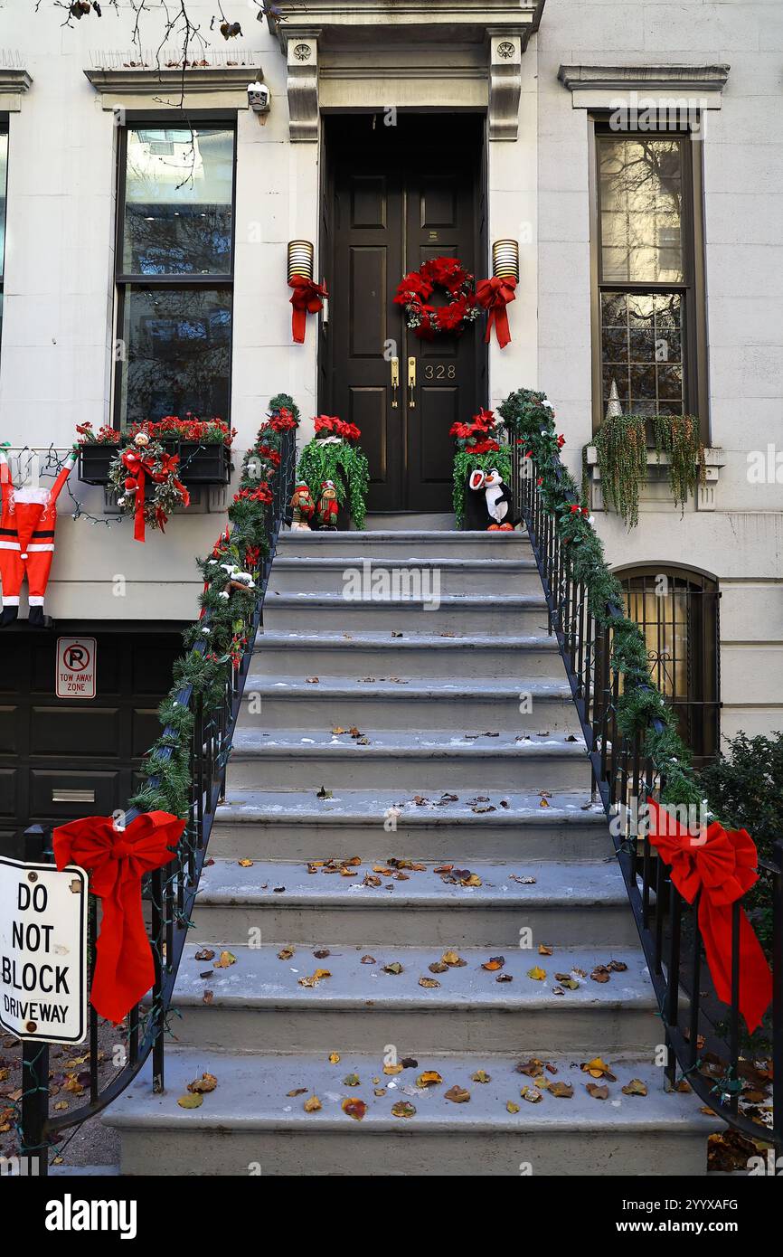 Christmas lights and decorations cover the stairs of a townhouse in the ...