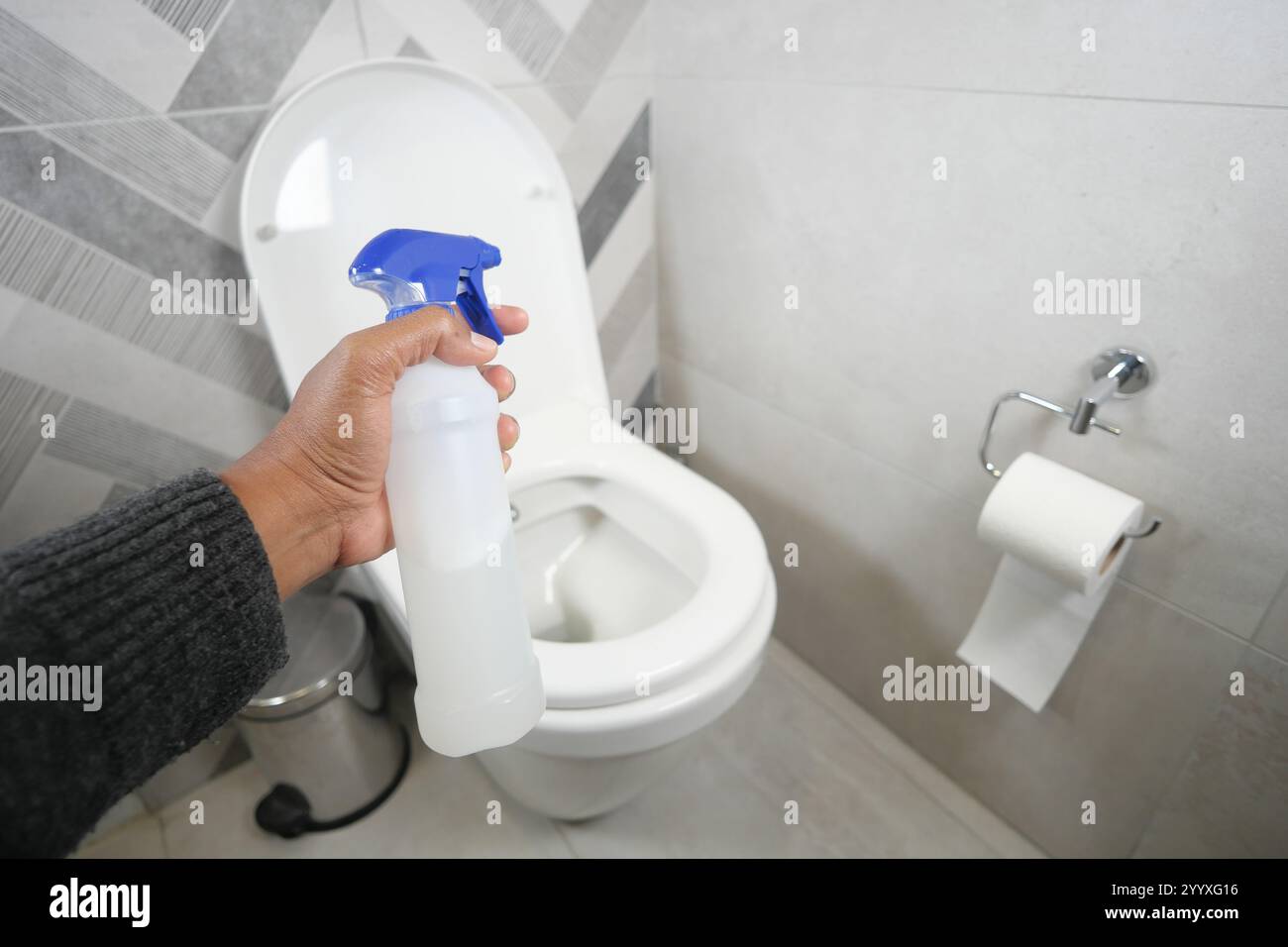 Applying a Cleaning Solution in a Bathroom Toilet Environment for ...