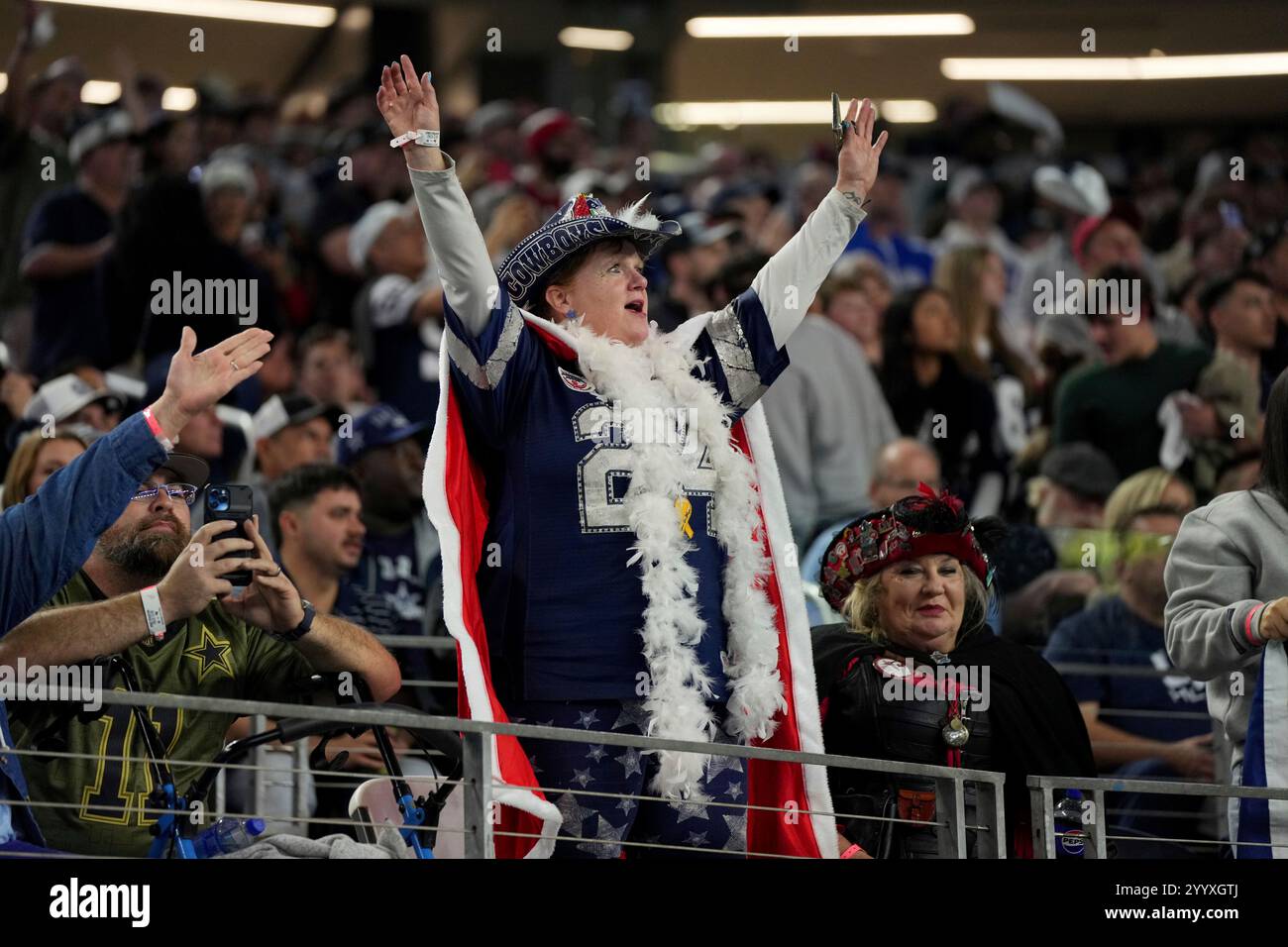 A Dallas Cowboys fan cheers on the team in the first half of an NFL ...