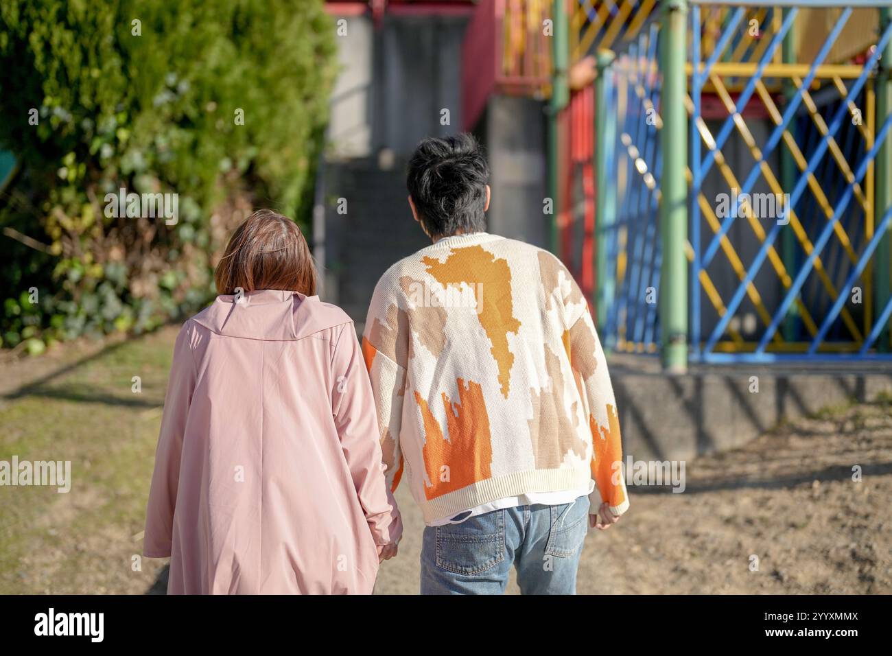 Couple in their 20s are having fun playing on playground equipment in ...