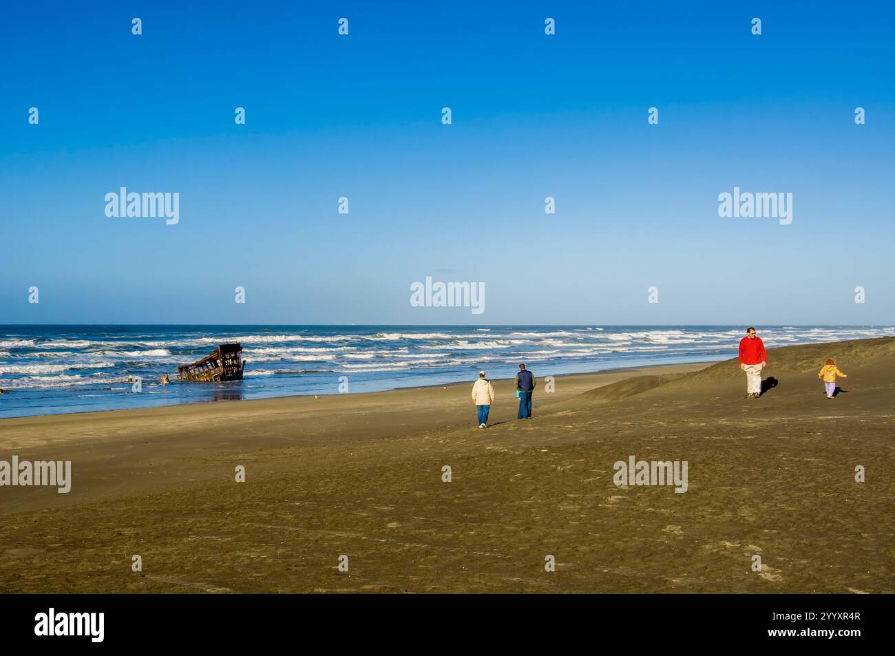 Family walking past Peter Iredale shipwreck on Fort Stevens State Park ...