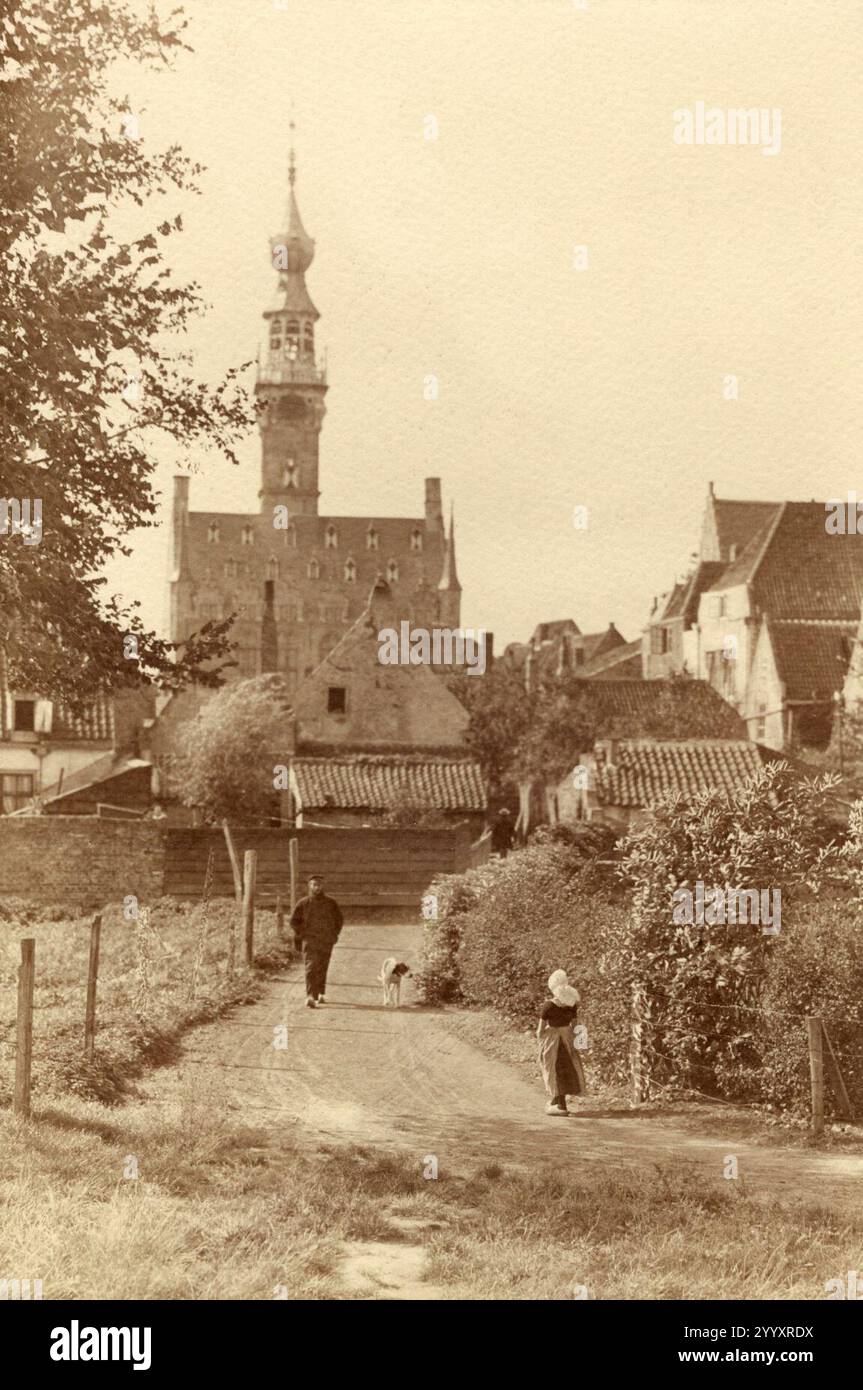 Een onverhard straatje in Veere, tussen tuinen en achterkanten van ...