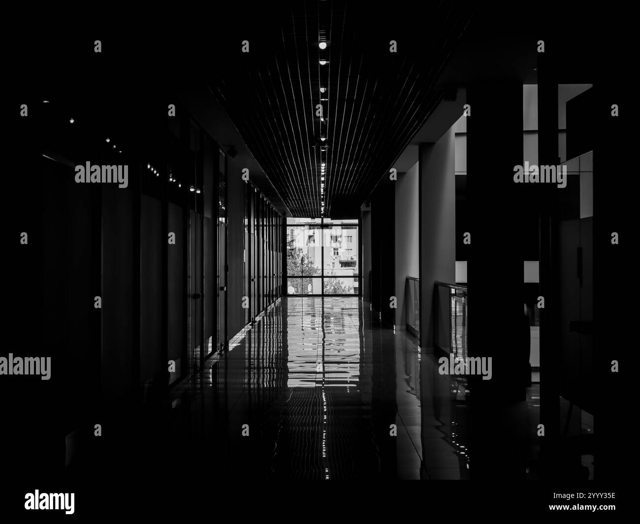 Dark mysterious corridor in building. Light at glass window with ...