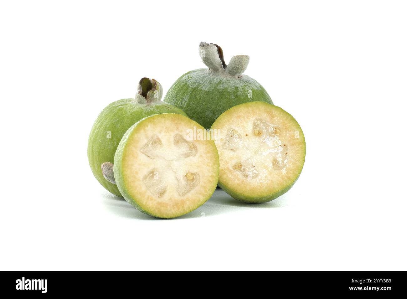Close-up of a whole feijoa fruit and a halved section showcasing its ...