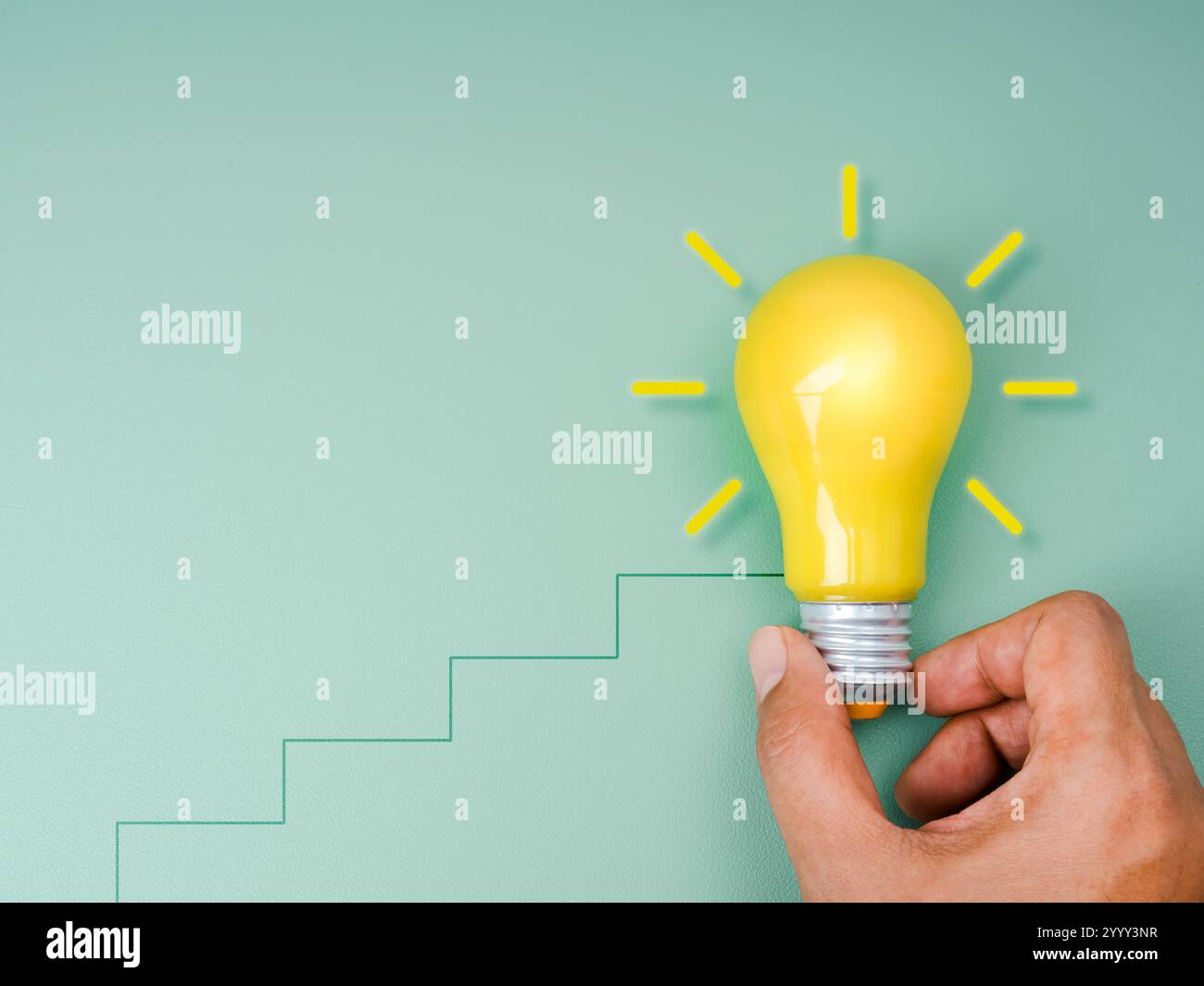Yellow light bulb in hand, holding on blue background, with line as a ...