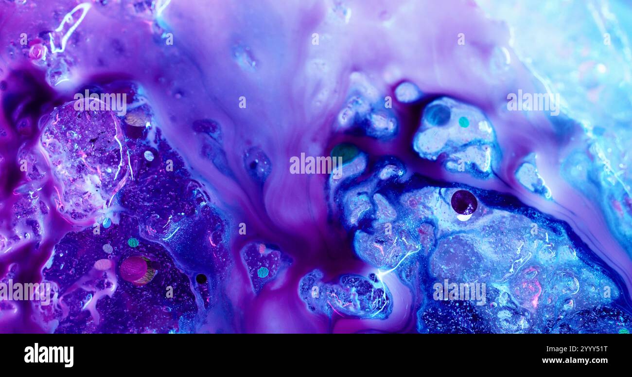 Violet fluid. Paint ice. Liquid purple watercolor flows on frozen blue ...
