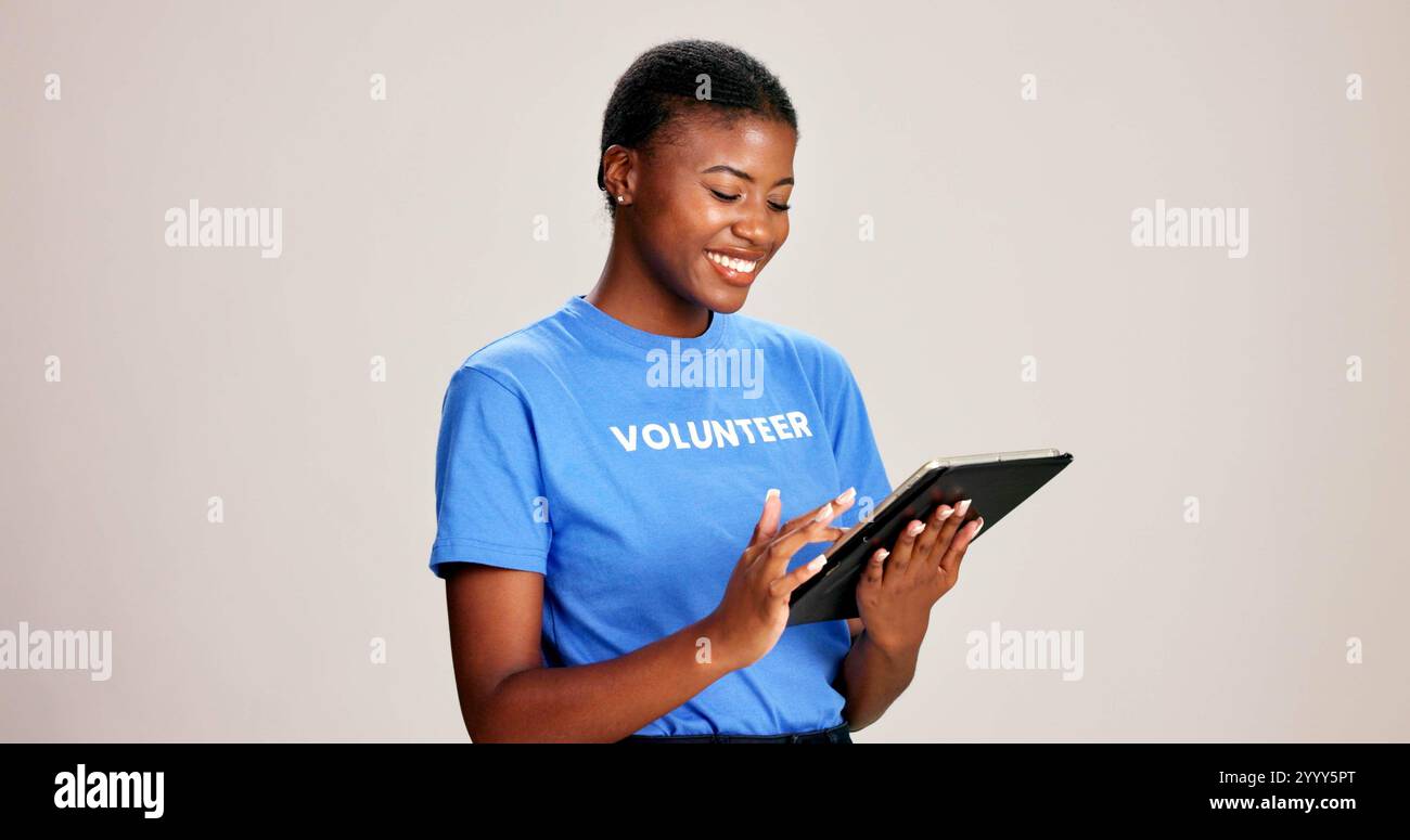 Happy, black woman or volunteer with tablet in studio for charity or ...