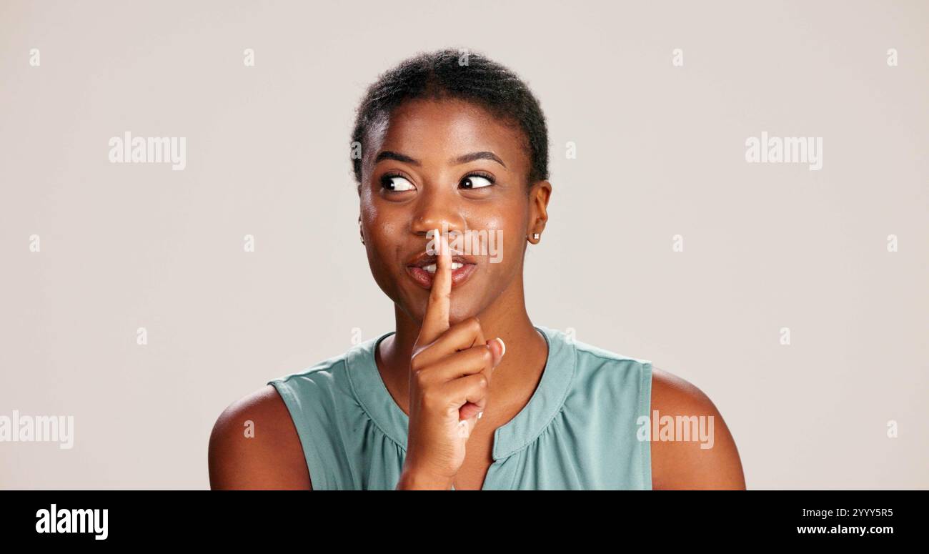 Black woman whisper finger hi-res stock photography and images - Alamy