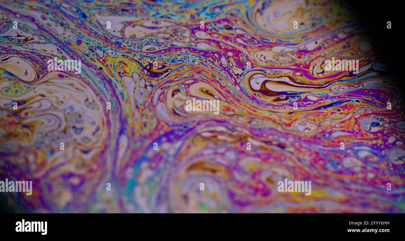 Gasoline rainbow. Oil dye droplets. Defocused multicolor purple green ...