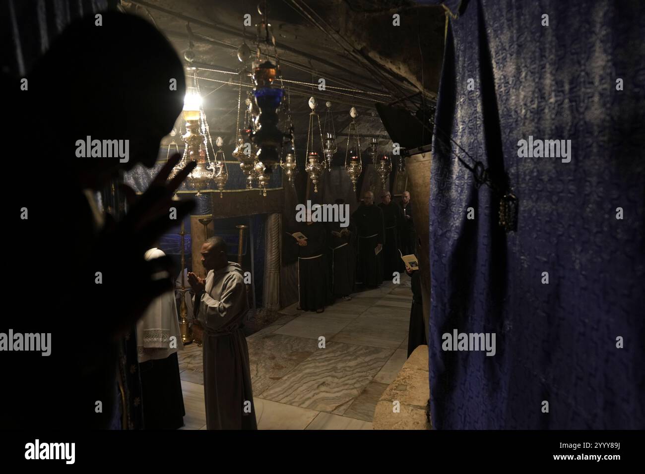 Priests pray in the Church of the Nativity, where Christians believe ...