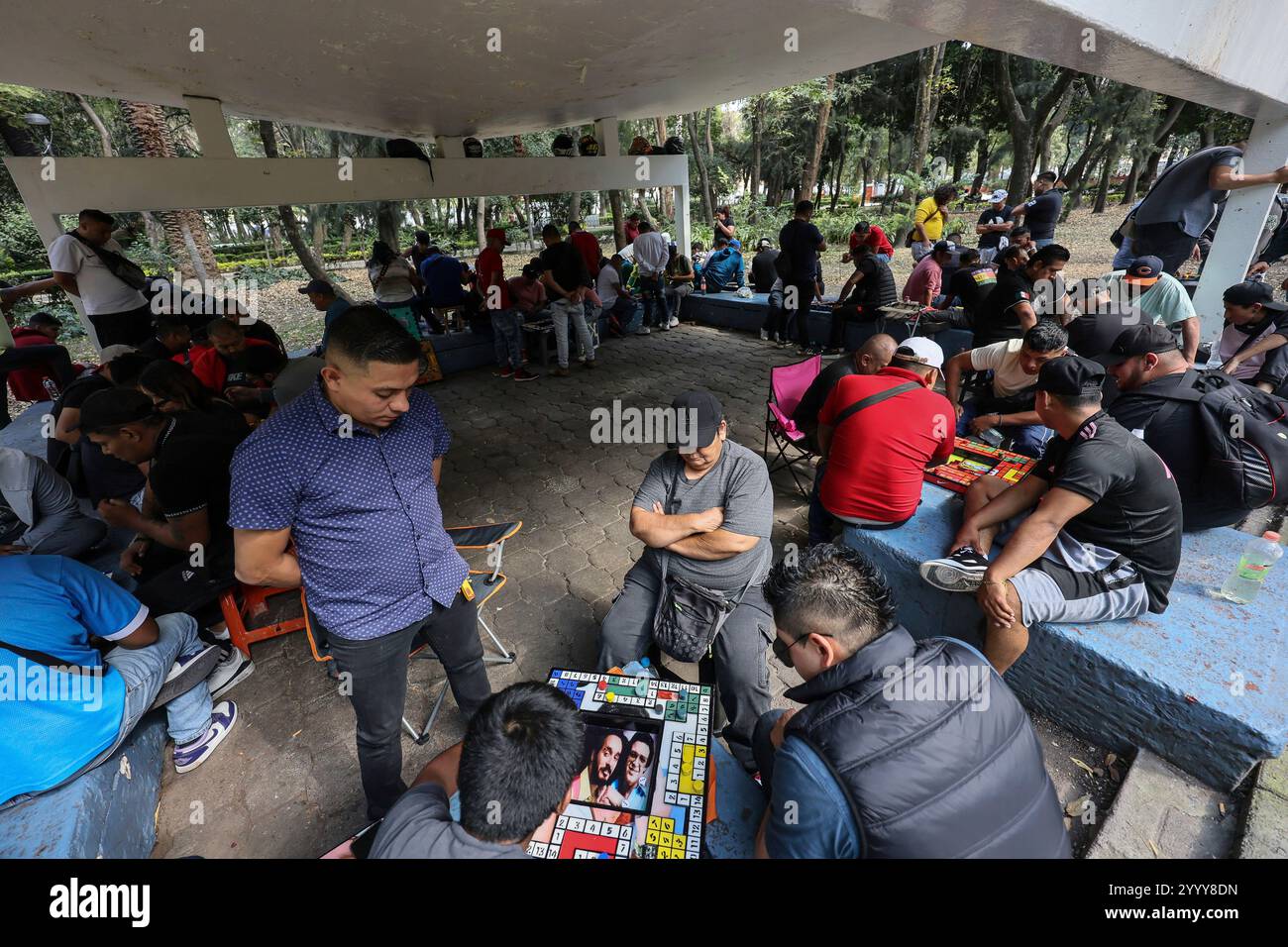 Rosa María Espinosa, center, plays Poleana, a board game invented in ...