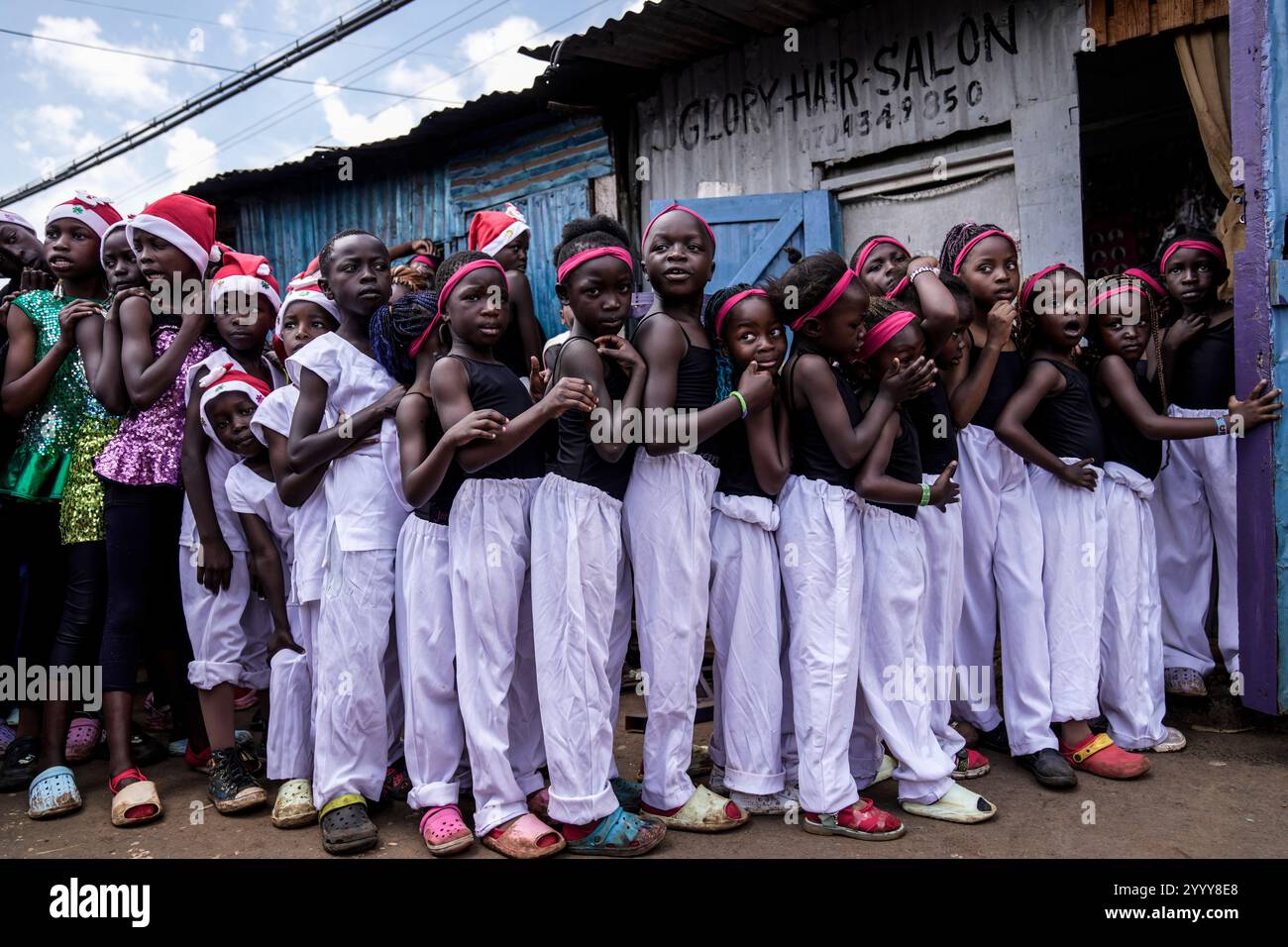 Young girls line up to get their makeup applied at a salon, prior to ...