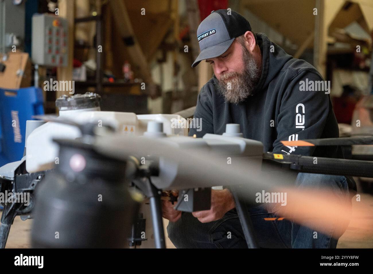 Russell Hedrick prepares a DJI drone to put crop cover on his farm ...