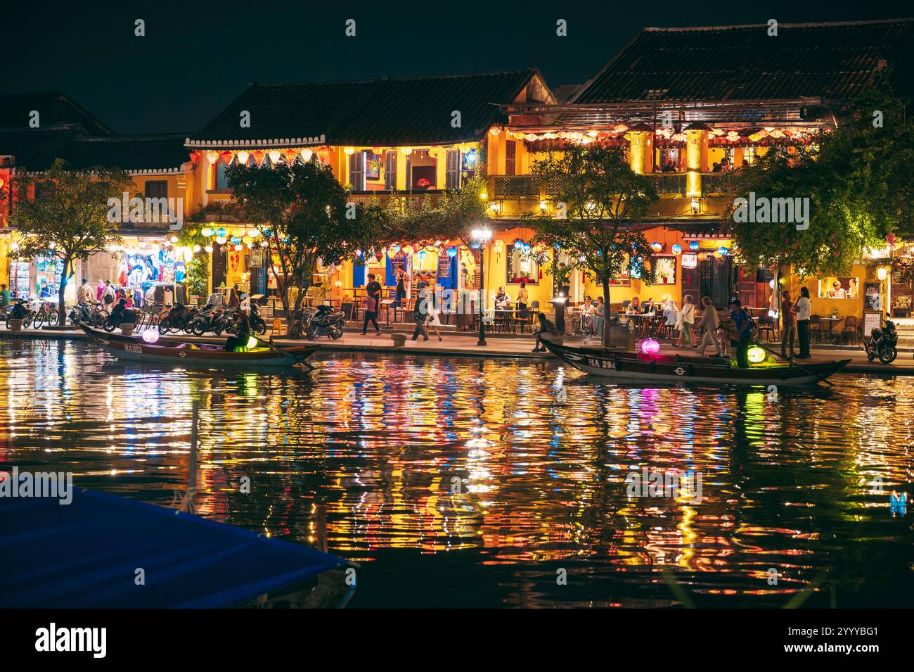 Hoi An ancient town and passenger boats on Thu Bon River at magic hour ...