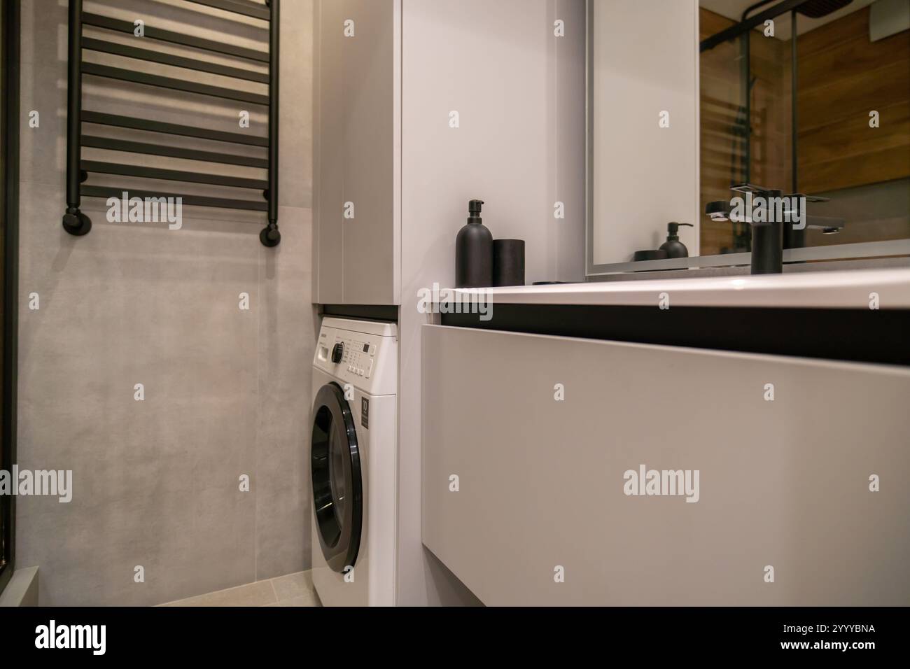 Modern bathroom with a built-in washing machine, sleek countertop sink ...