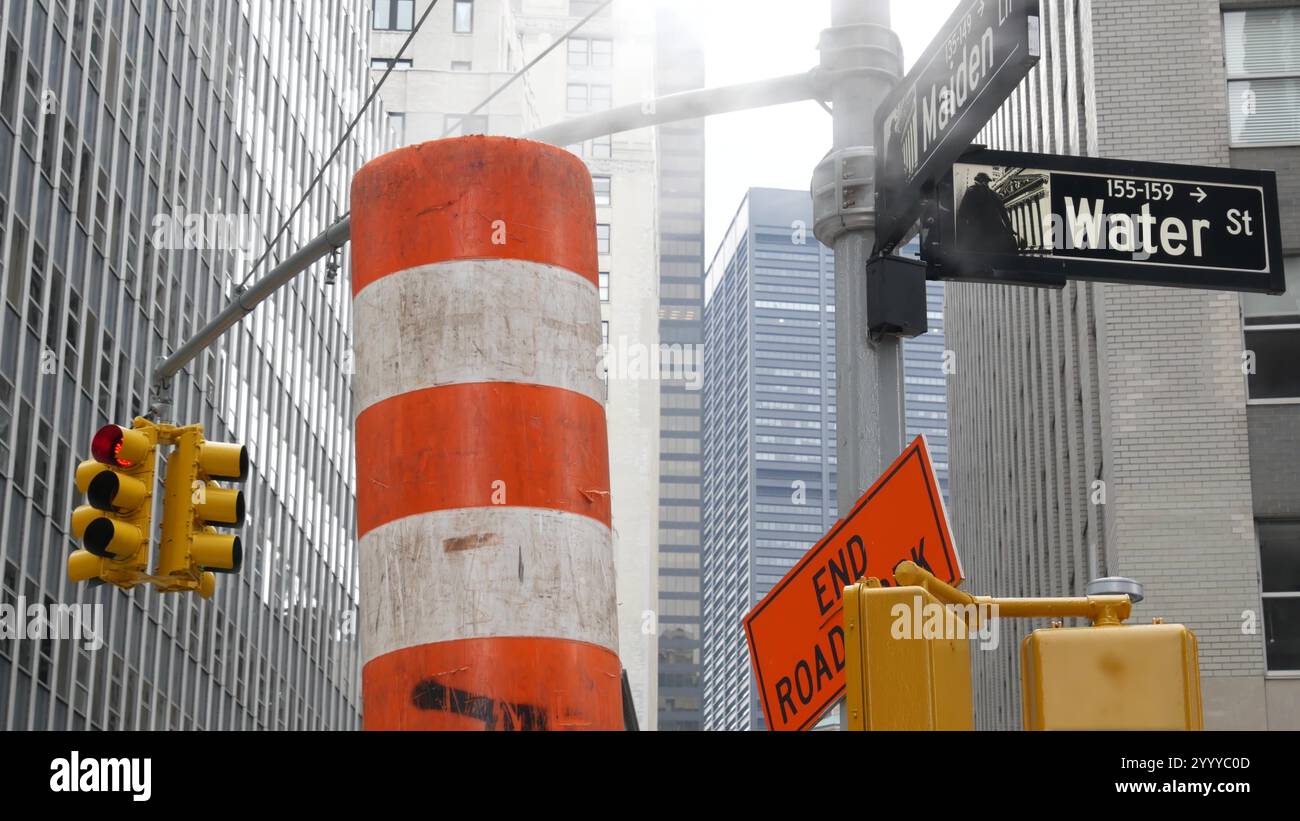 Steam vapor vented on New York City Water street, orange vapour tube ...