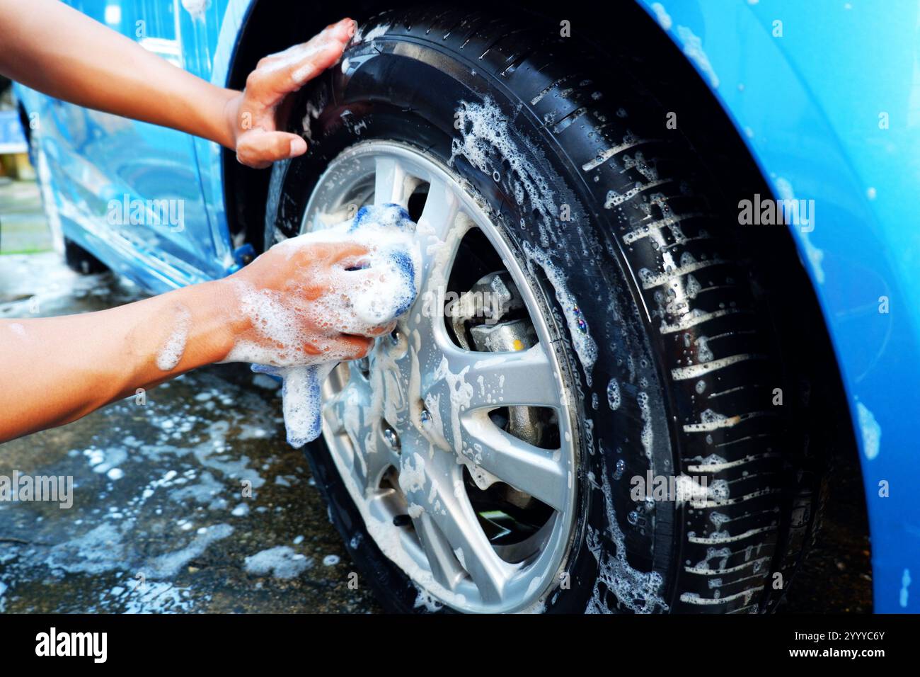 Cleaning the car wheels with microfiber cloth While washing the car ...