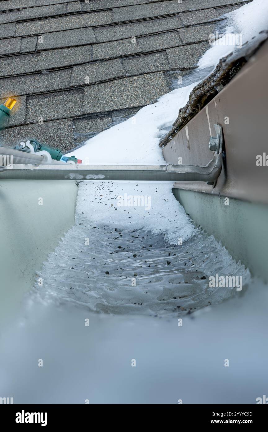 Ice and snow building up inside a rooftop gutter system on a ...