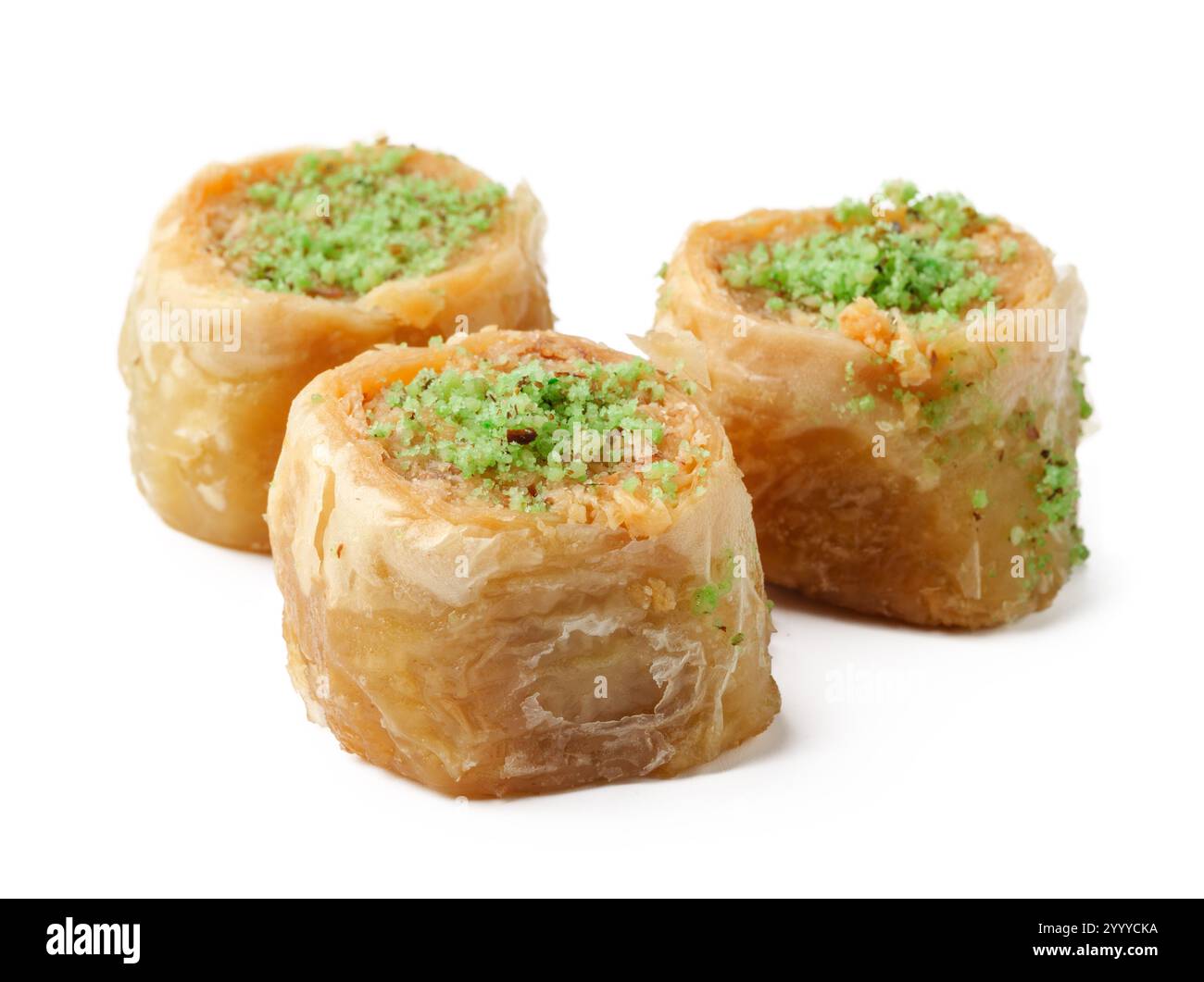 Delicious baklava rolls with pistachio topping served on a neutral ...
