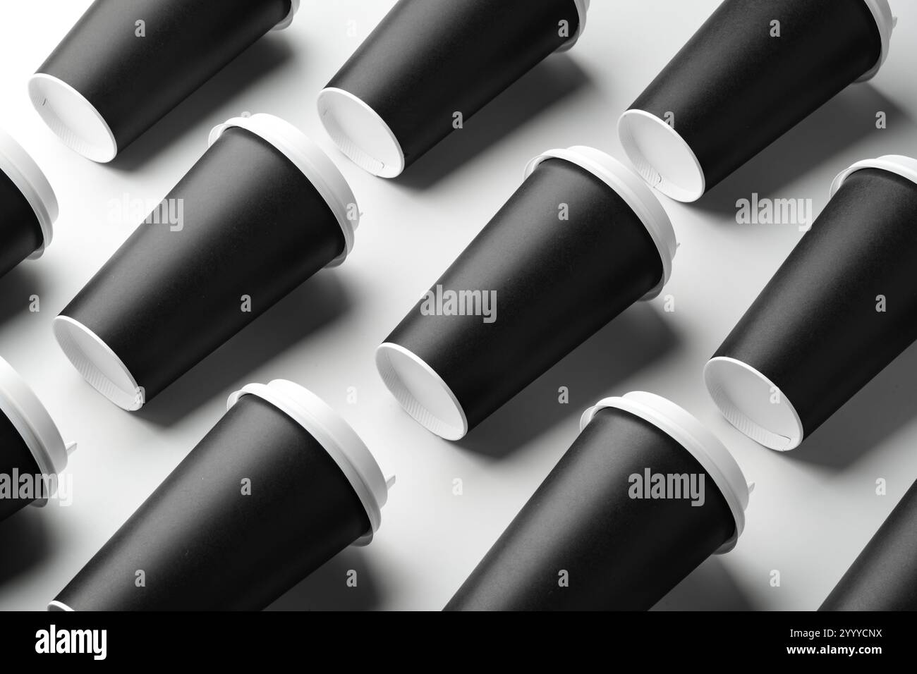 Multiple black takeaway coffee cups arranged in a repeating pattern on ...