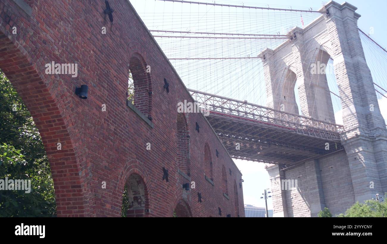 New York City Brooklyn Bridge from Dumbo. Red brick wall, old historic ...