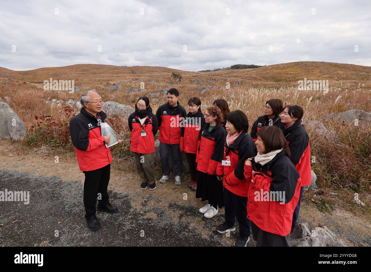Guides listen to a geoguide, a geopark guide, at the Akiyoshi plateau ...