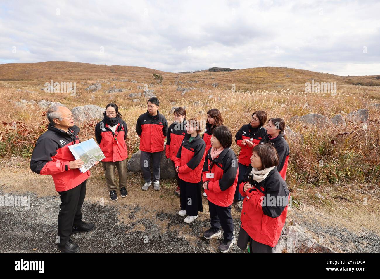 Guides listen to a geoguide, a geopark guide, at the Akiyoshi plateau ...
