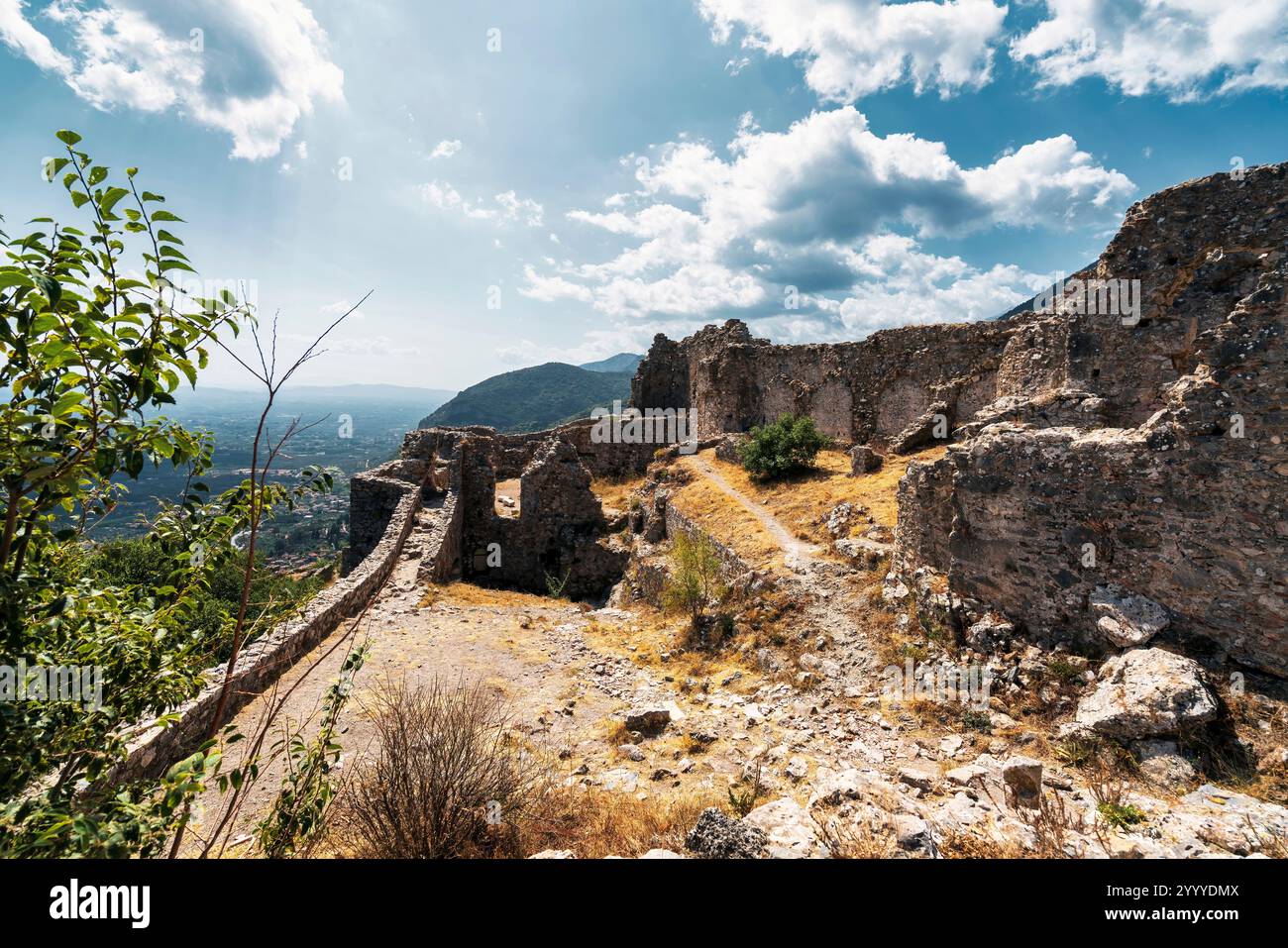 A crumbling stone archway atop the ruins of Mystras, Greece, offering ...