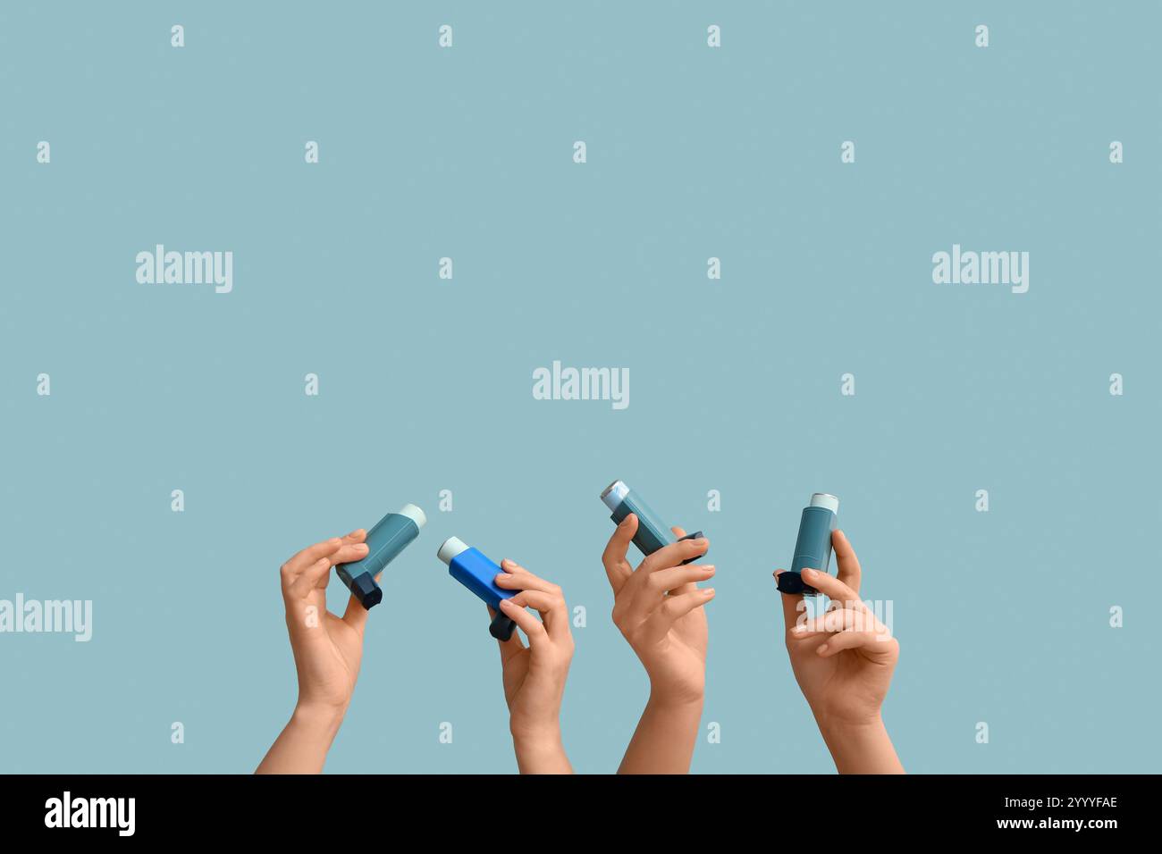 Female hands with modern asthma inhalers on blue background Stock Photo ...