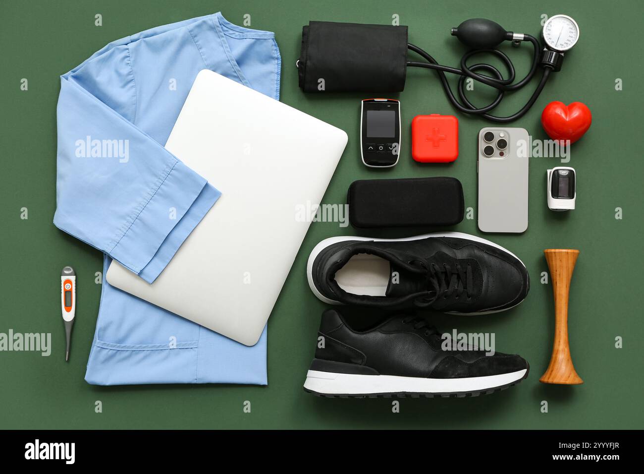 Medical student's uniform with supplies and modern devices on green ...