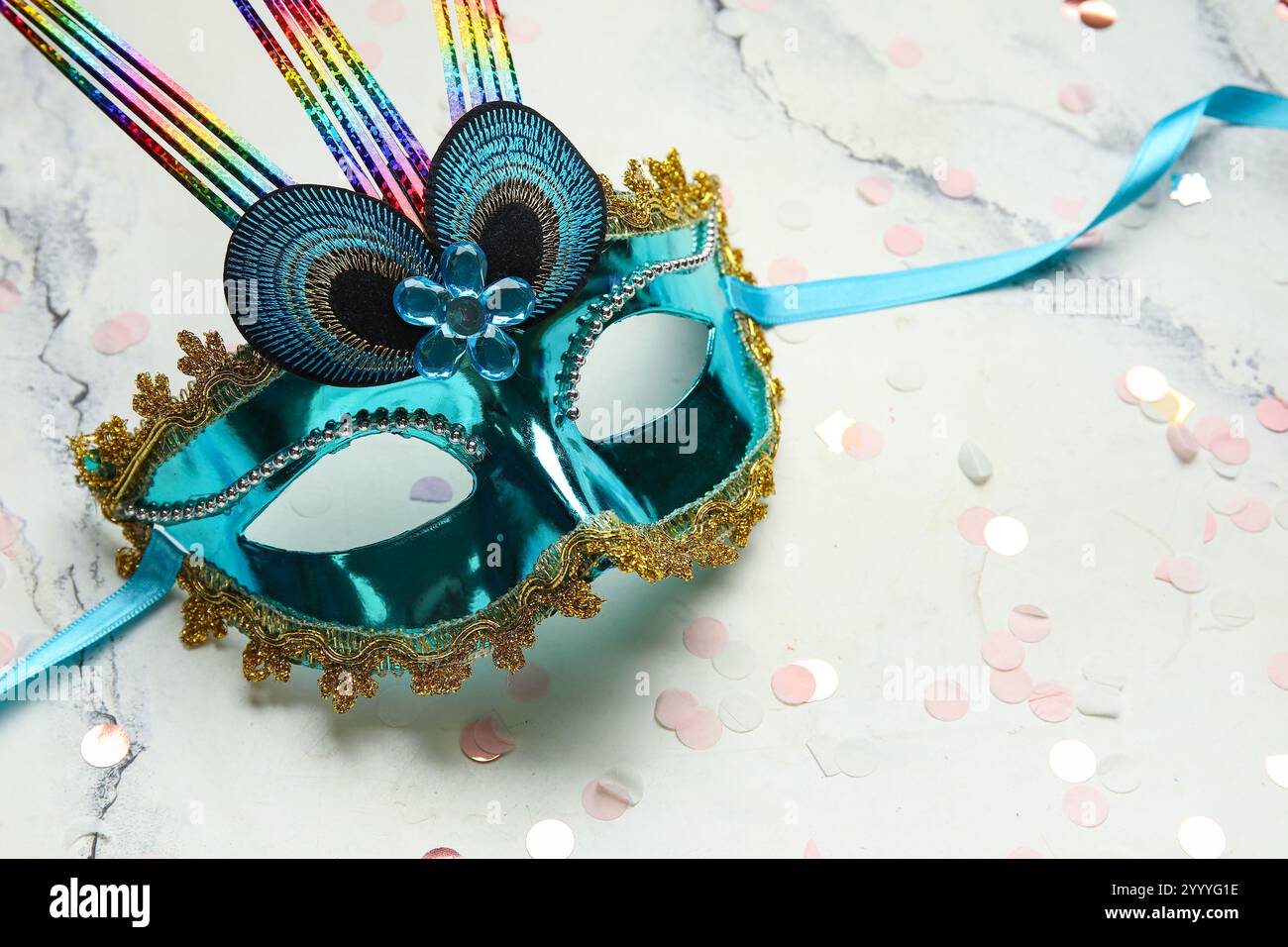 Beautiful blue carnival mask with confetti on white background. Closeup ...