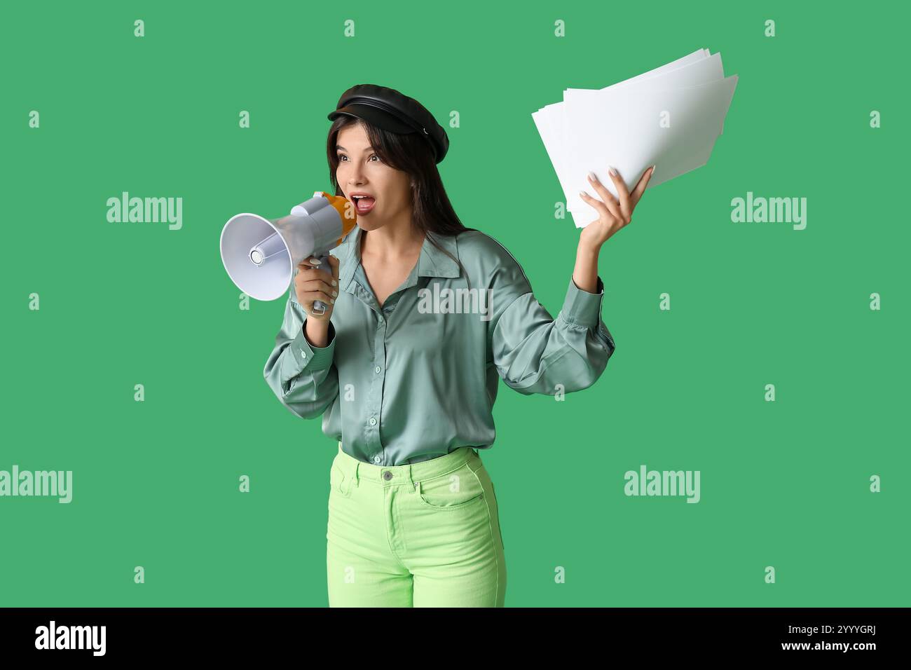 Young shocked female film director with megaphone and script screaming ...