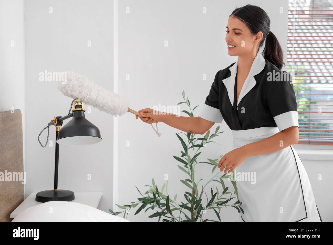Young chambermaid cleaning hotel room Stock Photo - Alamy