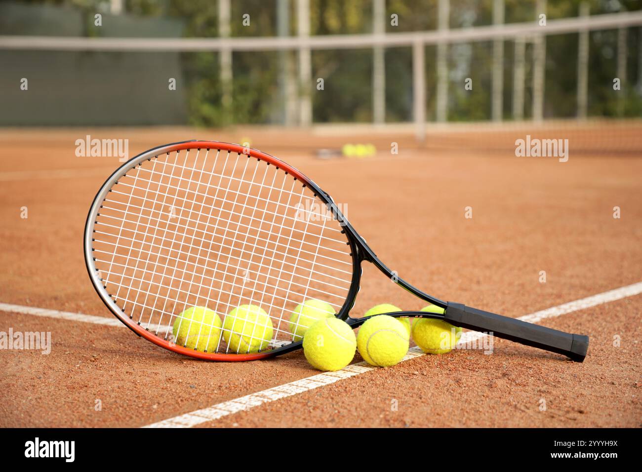 Racket and tennis balls on court floor Stock Photo - Alamy