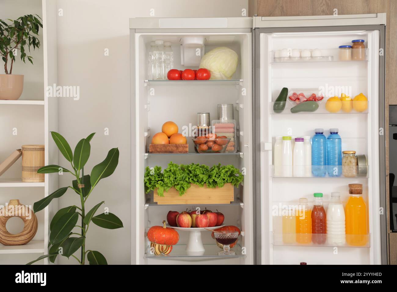 Open fridge full of fresh food in modern kitchen Stock Photo - Alamy