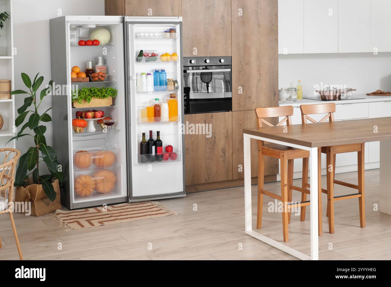 Open fridge full of fresh food in modern kitchen Stock Photo - Alamy